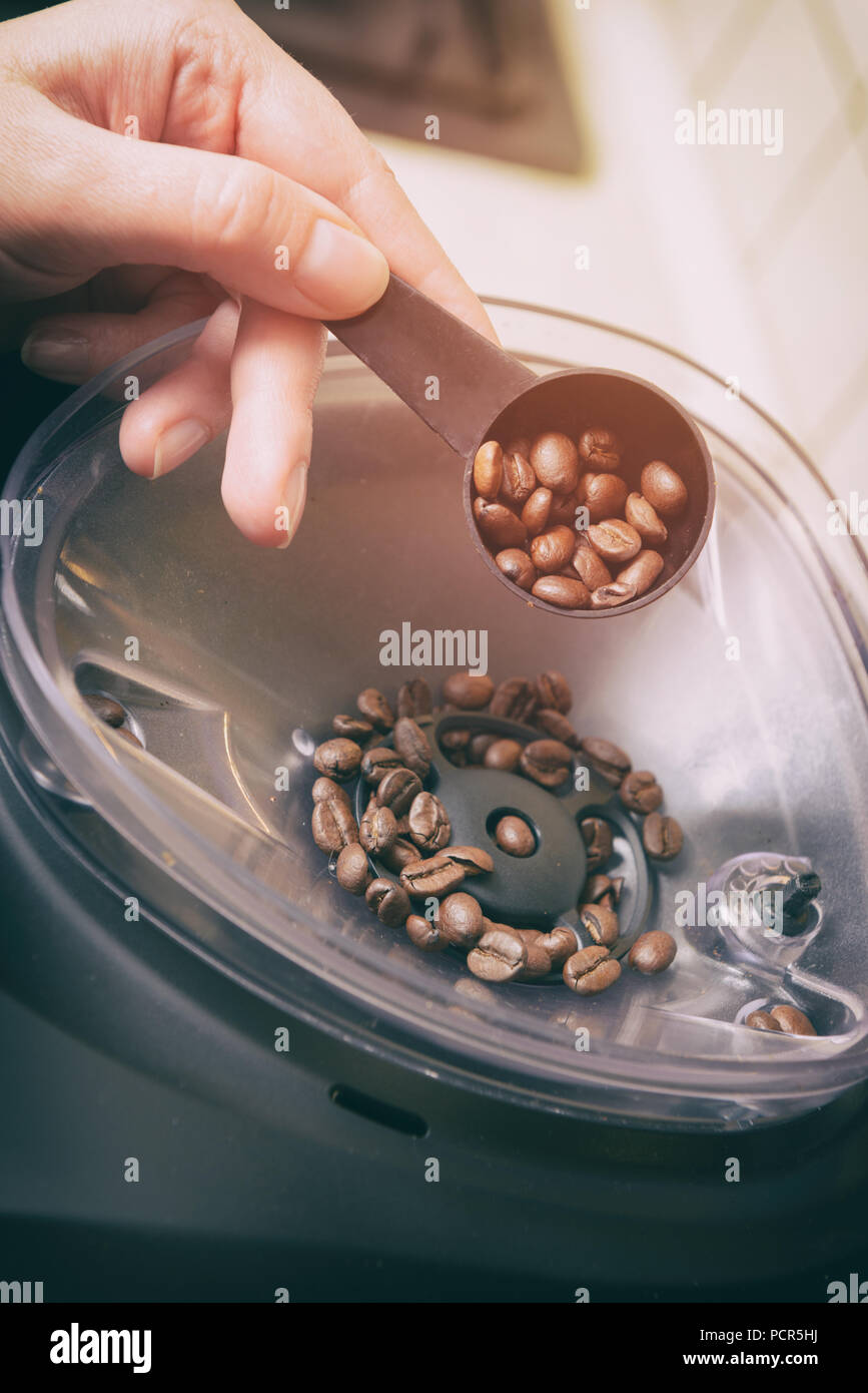 Adding coffee beans to the built in grinder in the coffee maker Stock ...