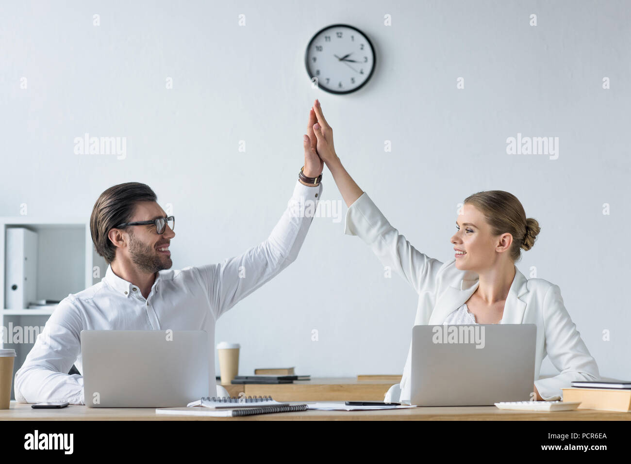 Female workers celebrating high five hi-res stock photography and ...