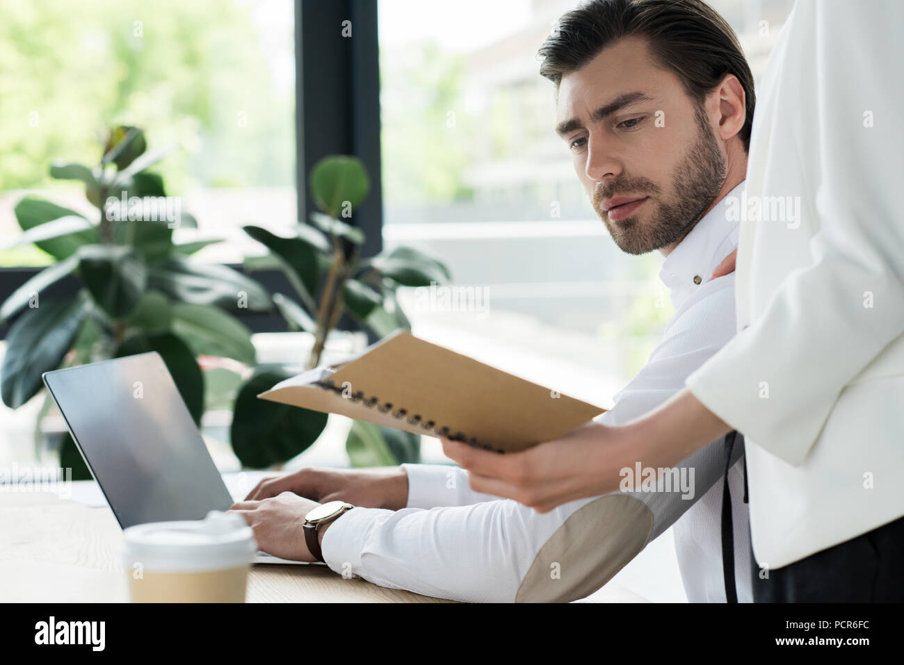 cropped shot of secretary showing notes to boss at office Stock Photo ...