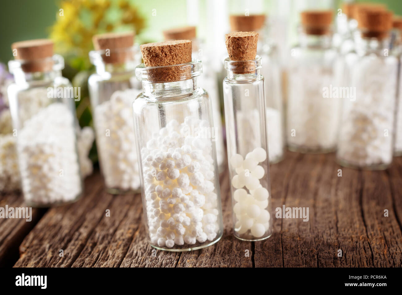 Homeopathic lactose sugar globules in glass bottles Stock Photo - Alamy