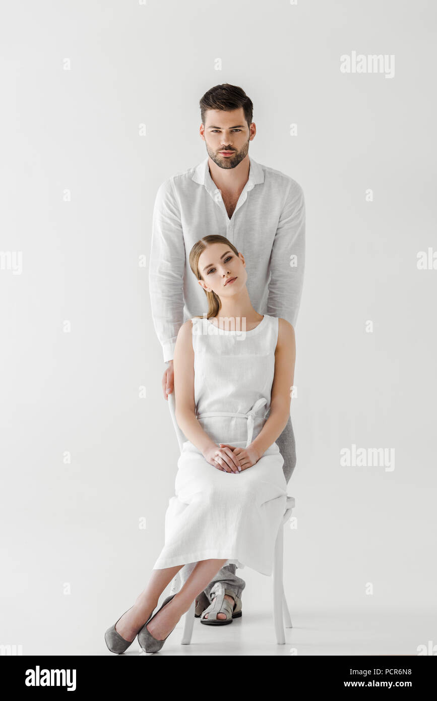 attractive woman in linen white dress sitting on chair while her ...