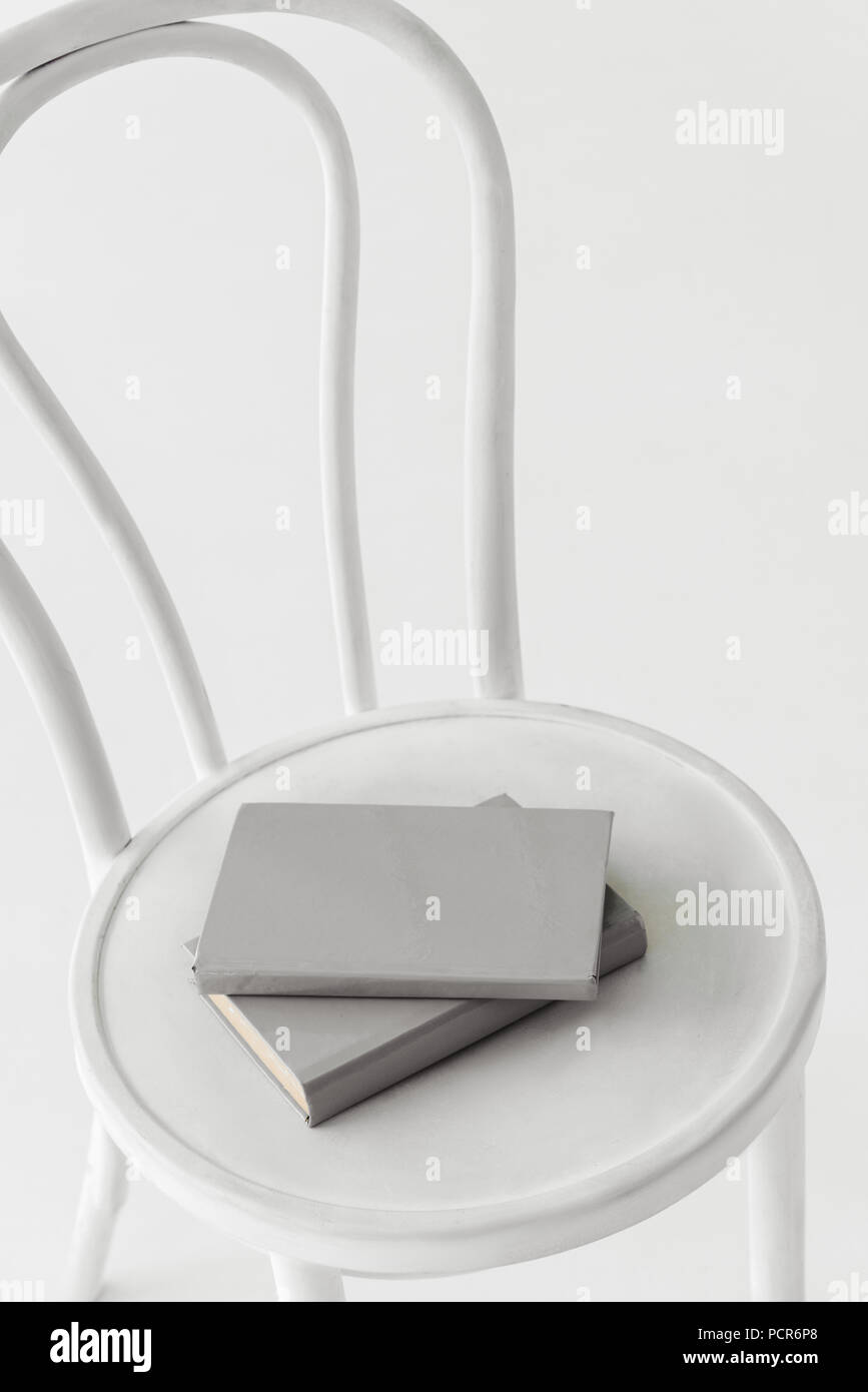 close up view of books on chair isolated on grey background Stock Photo ...