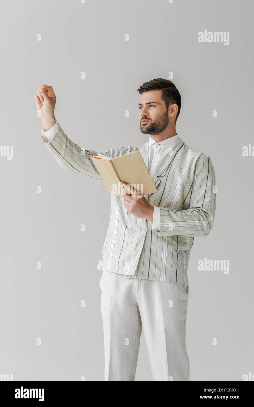 religious young man with bible making sign of cross isolated on white ...