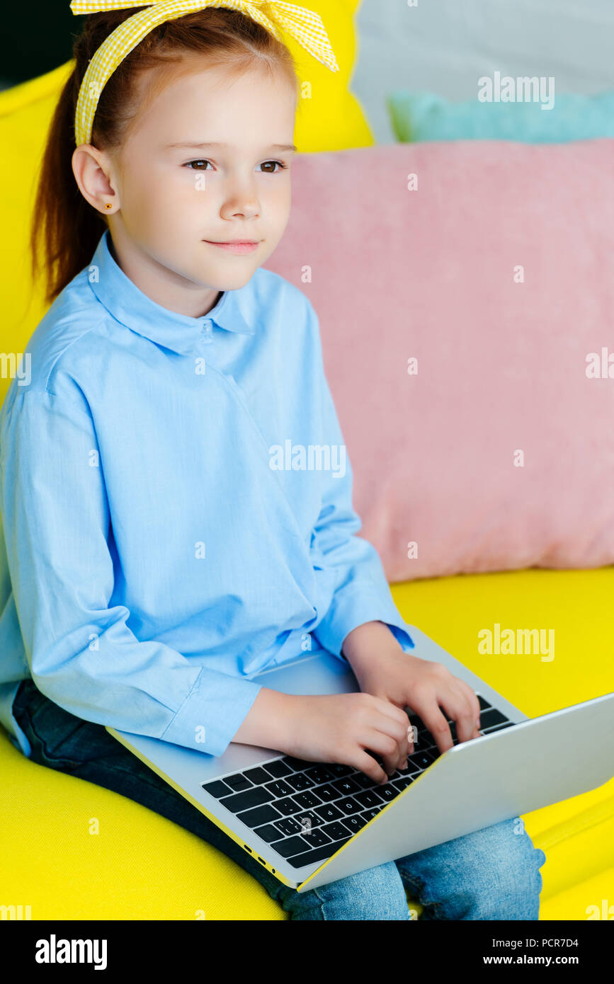 adorable little redhead child sitting and using laptop Stock Photo - Alamy