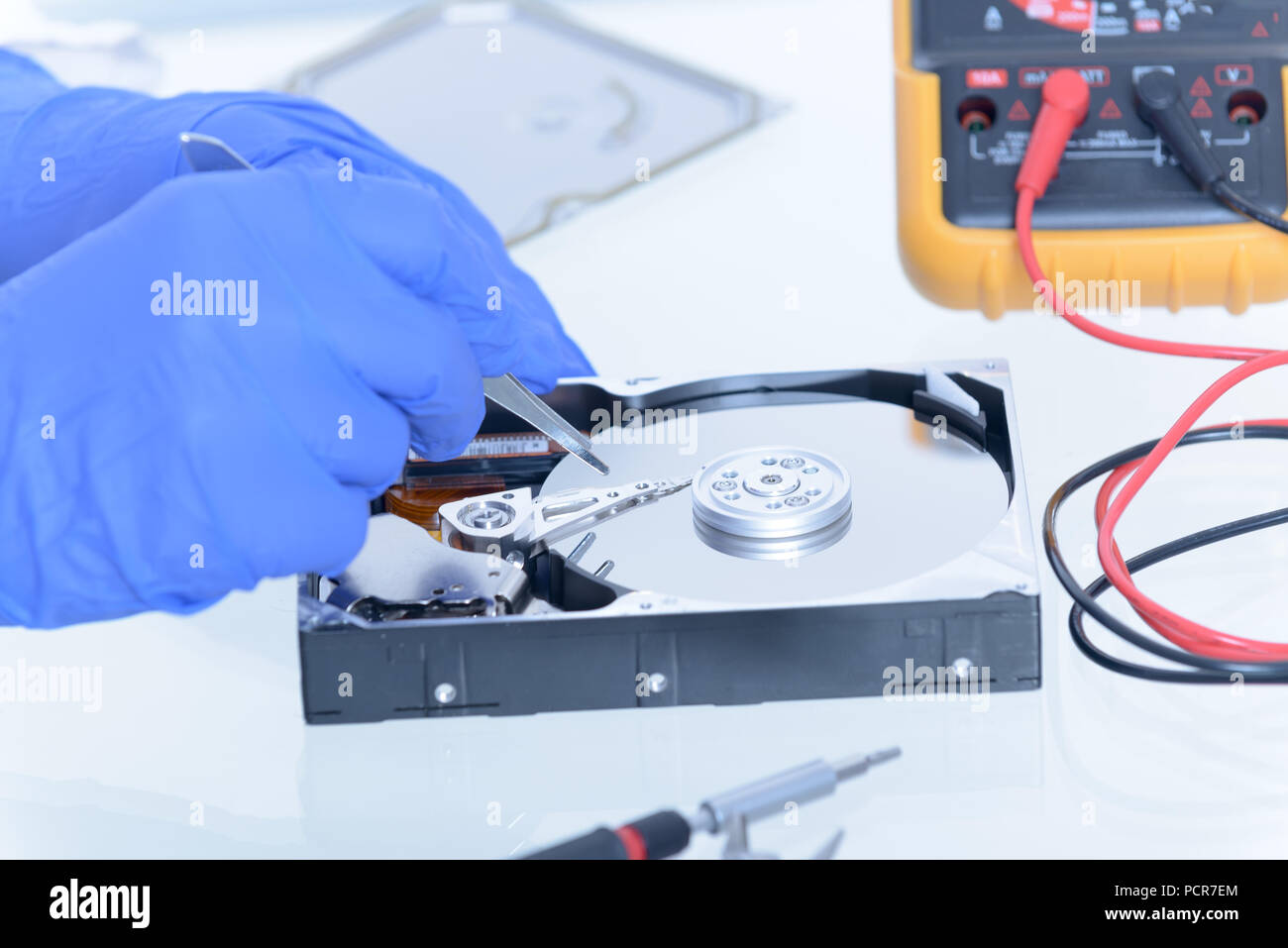 Service man fixing disk failure, hands protected with gloves Stock ...