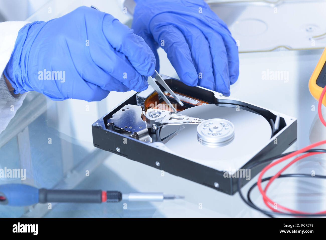 Service man fixing disk failure, hands protected with gloves Stock ...