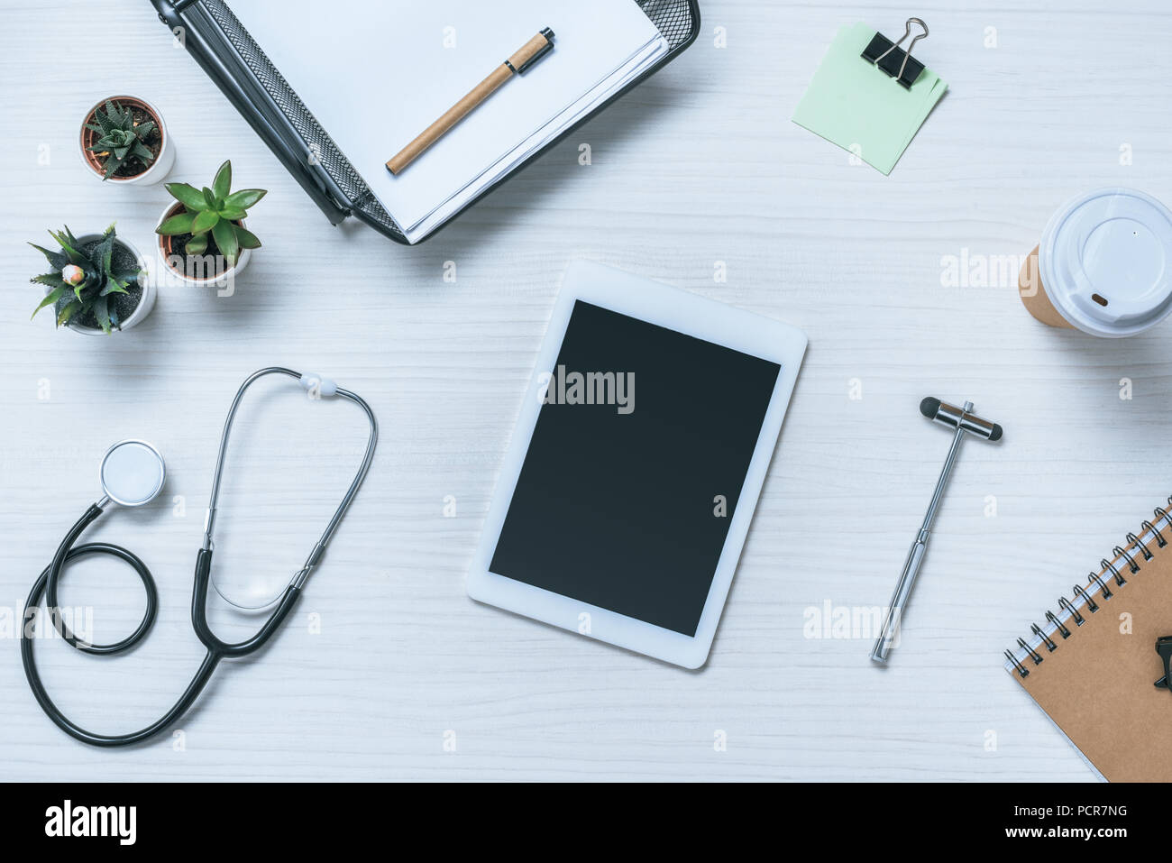 top view of digital tablet with blank screen, stethoscope, reflex ...