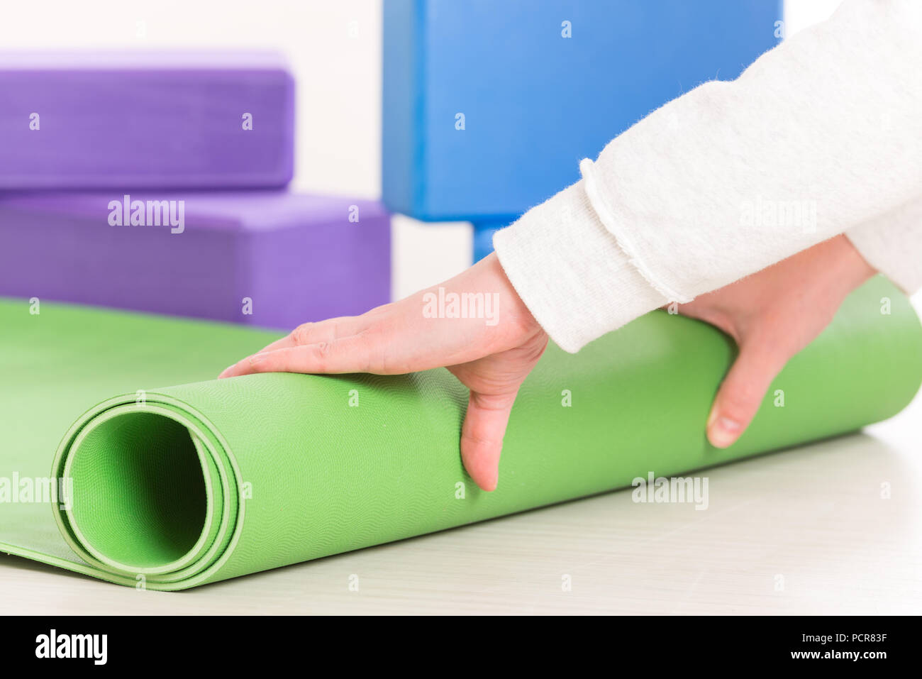 Woman rolling up fitness mat hi-res stock photography and images - Alamy