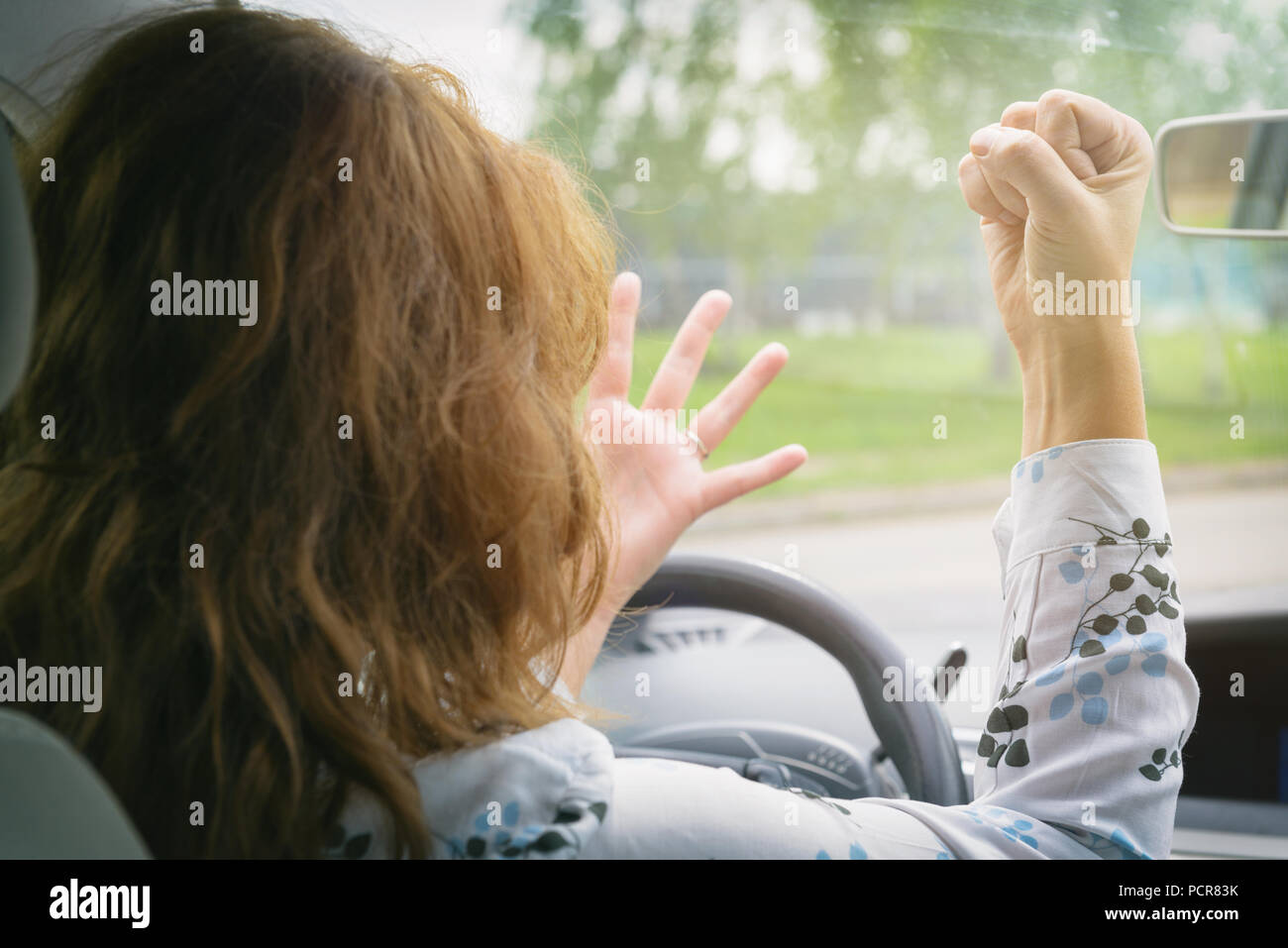 Angry woman screaming and gesturing while driving a car. Negative human ...