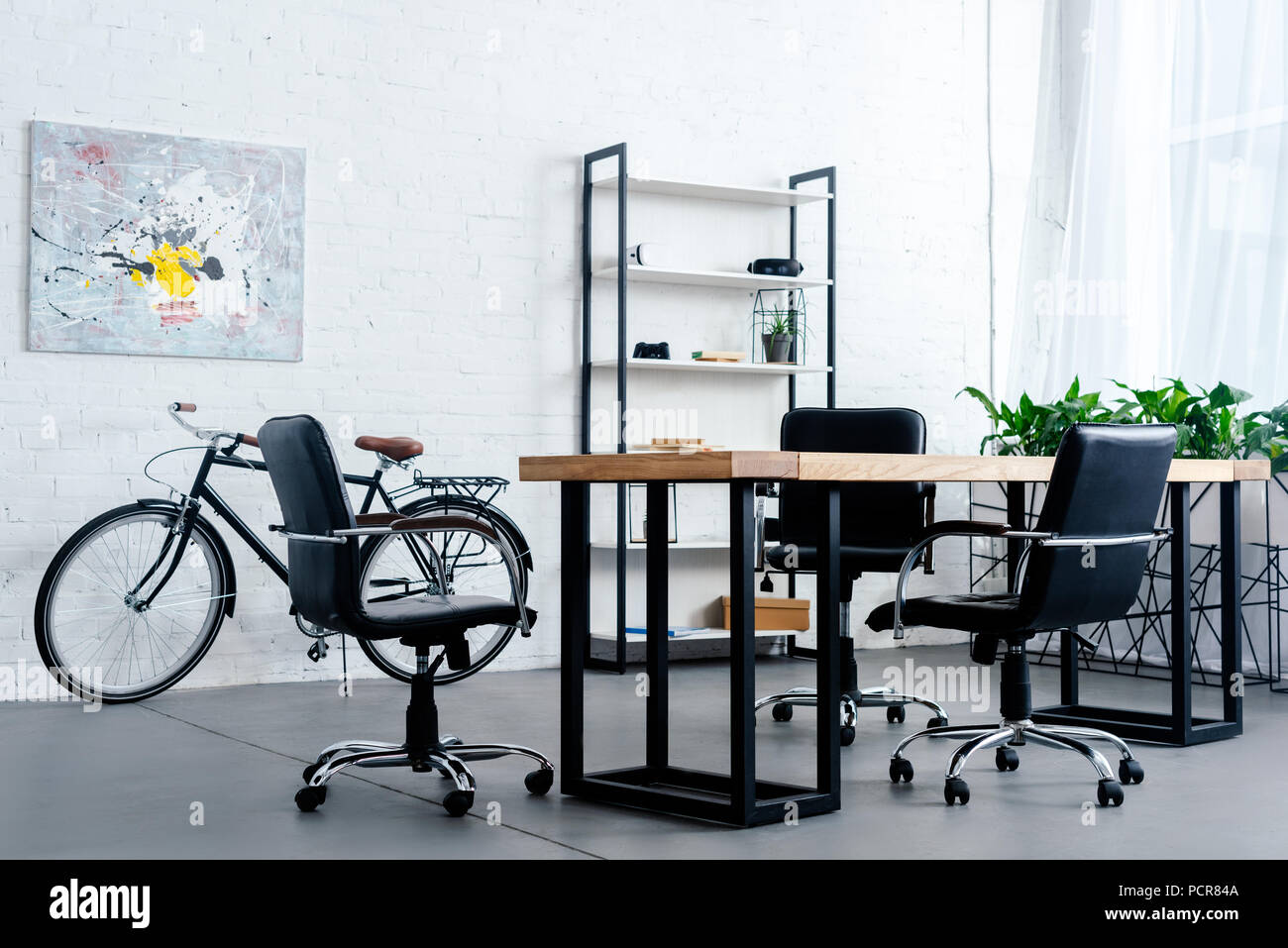 modern office interior with bicycle, table and chairs Stock Photo - Alamy