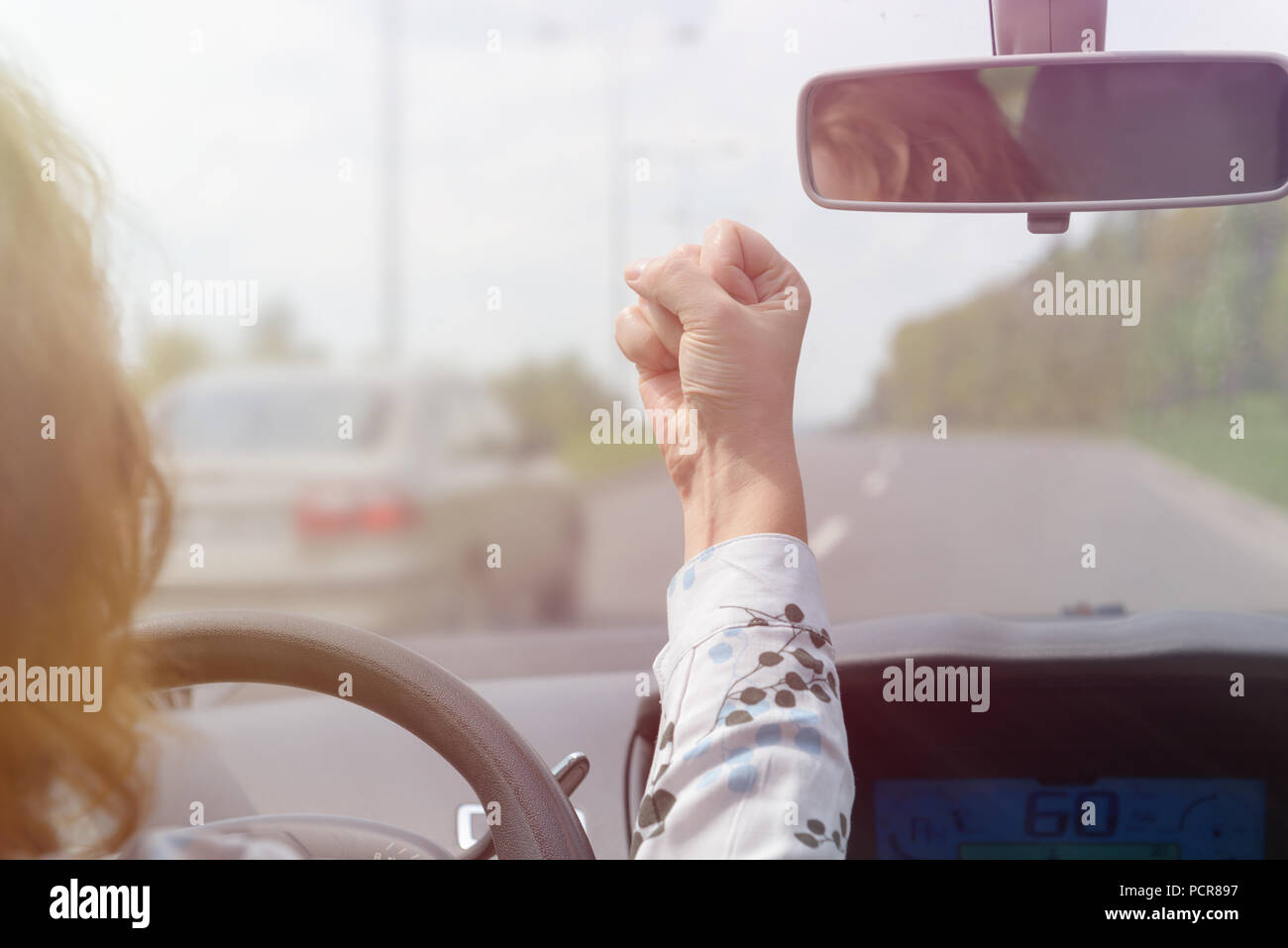 Angry woman screaming and gesturing while driving a car. Negative human ...