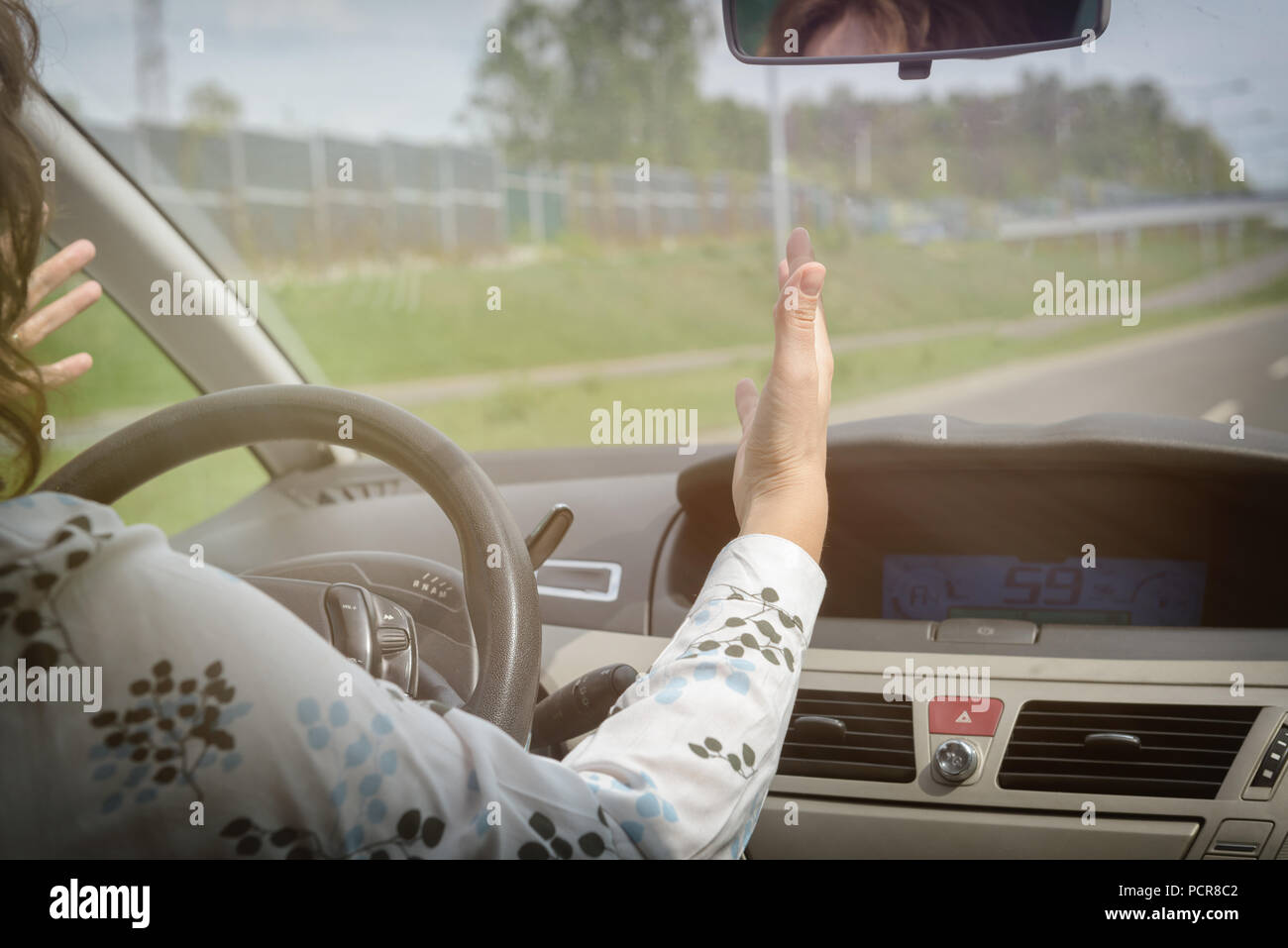 Angry woman screaming and gesturing while driving a car. Negative human ...