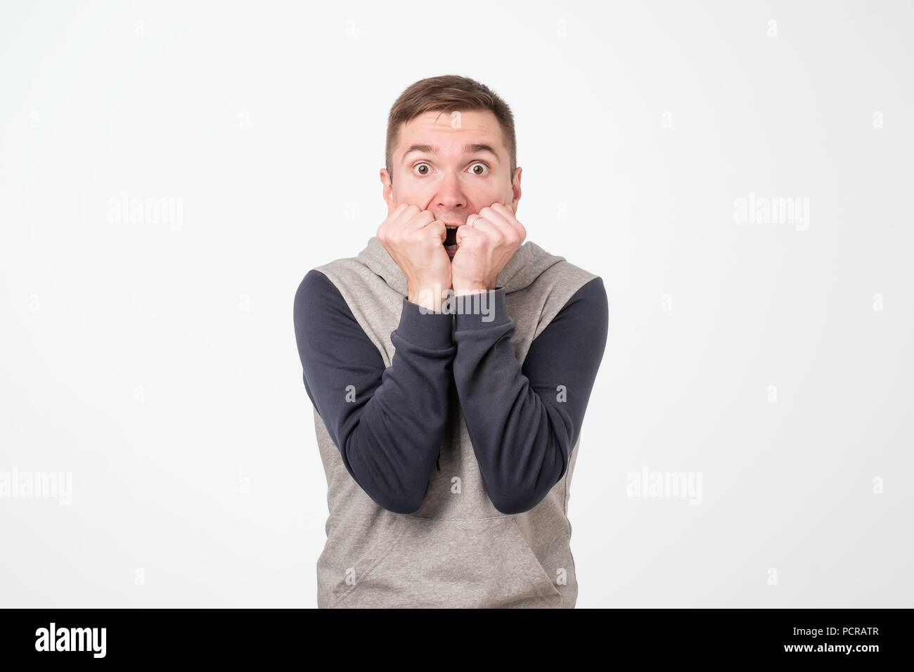Boy covering mouth hands hi-res stock photography and images - Alamy