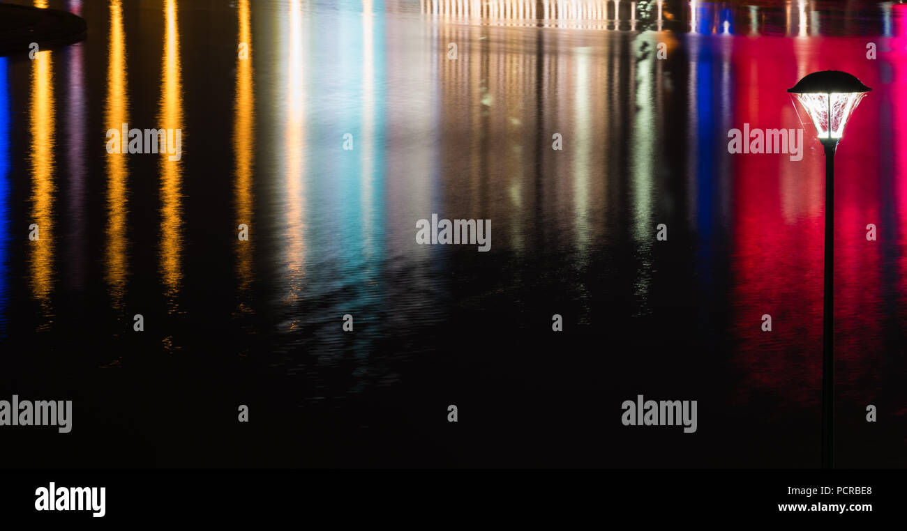 Colorful reflection on the water with a street lamp Stock Photo - Alamy