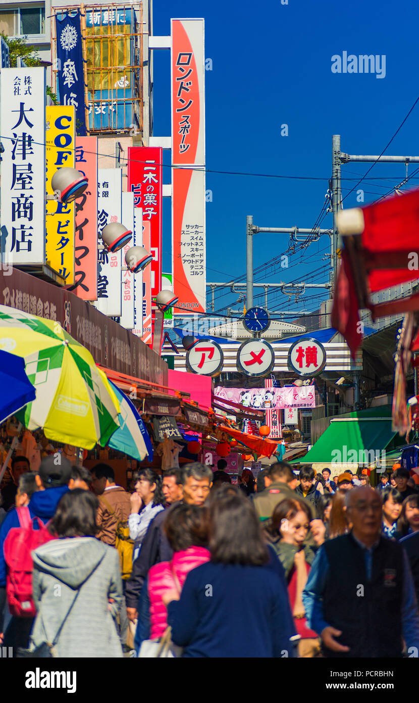 People stroll along the famous Ameyoko shopping street in Ueno District ...