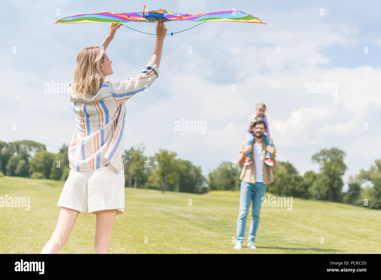 Young woman carrying girl kite hi-res stock photography and images - Alamy