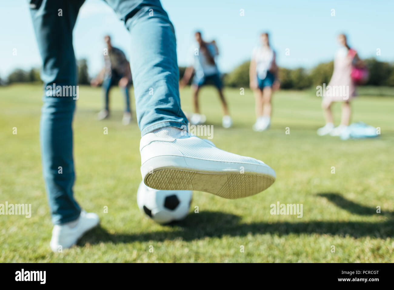 Boy playing soccer with friends hi-res stock photography and images - Alamy