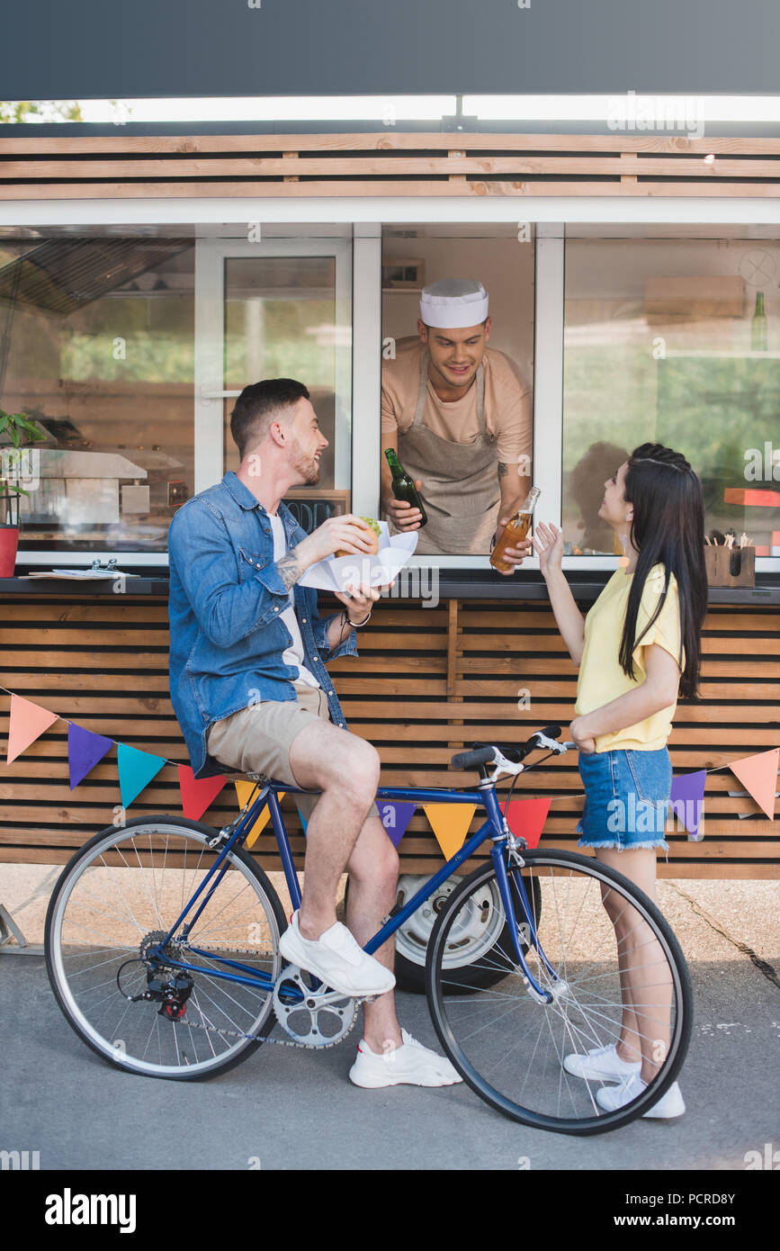 chef giving drinks to customers from food truck Stock Photo - Alamy