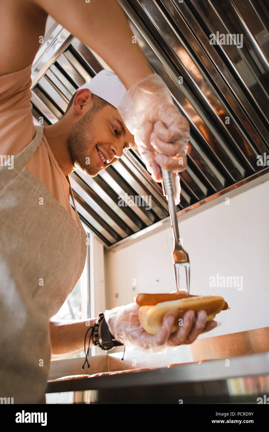 low angle view of chef preparing hod dog in food truck Stock Photo - Alamy
