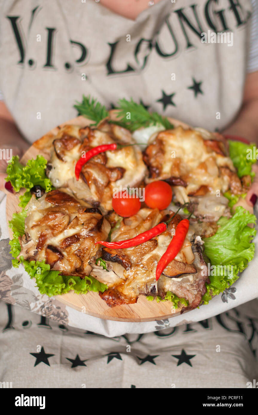 baked chicken on a large platter. in the hands of food. useful dinner ...