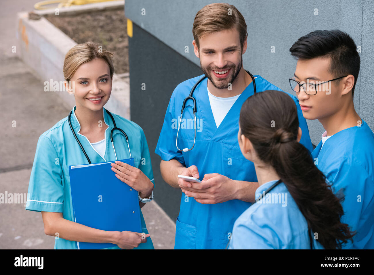 high angle view of multicultural medical students standing near medical ...