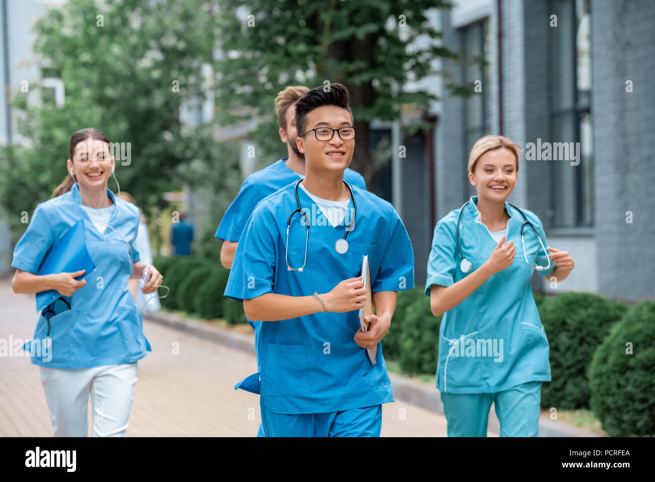 multiethnic students running near medical university Stock Photo - Alamy