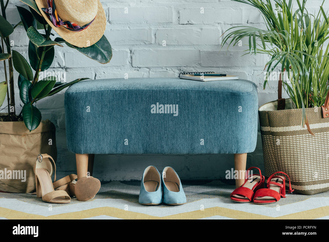 different shoes under chair in corridor at home Stock Photo - Alamy