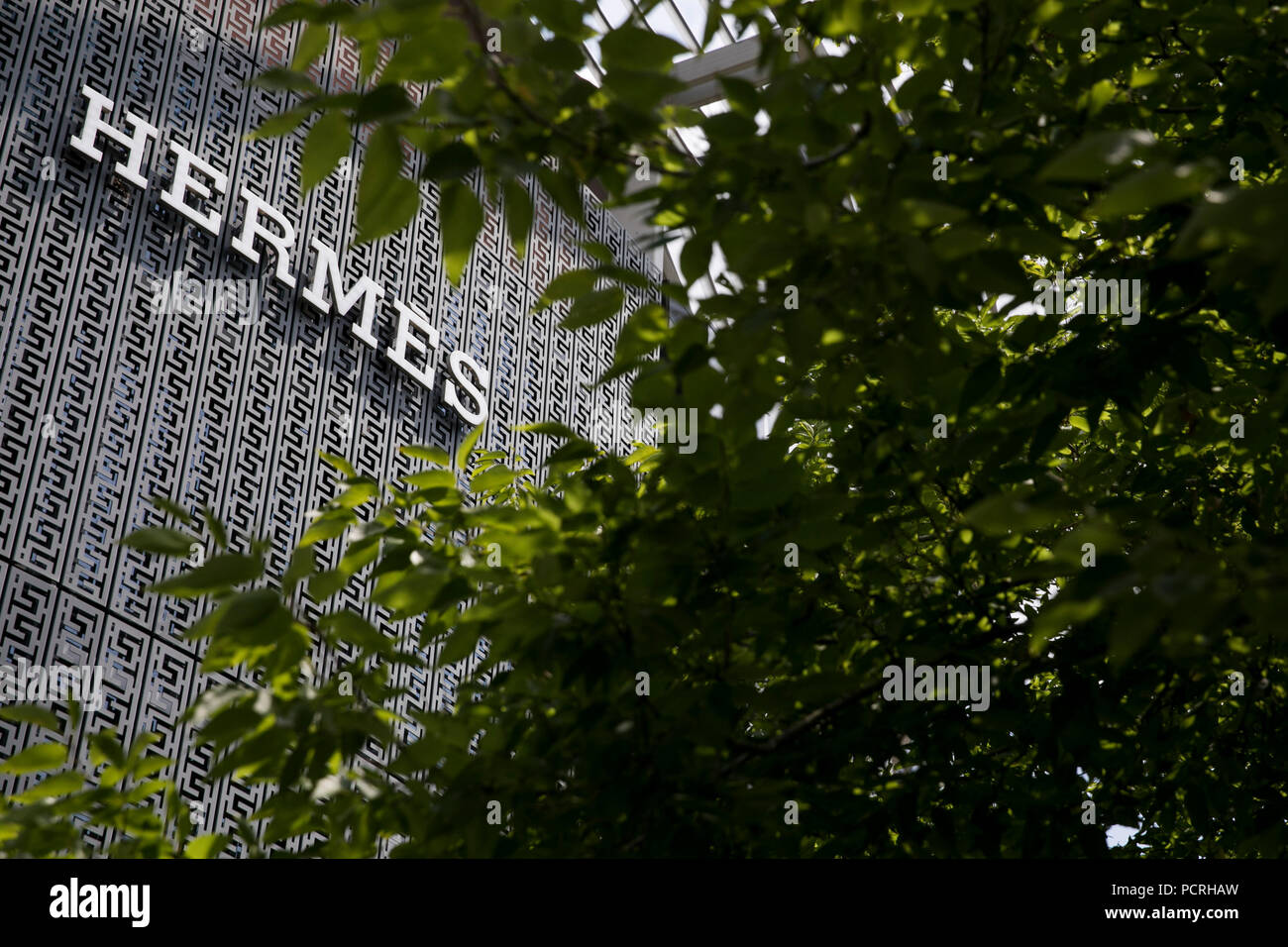 A logo sign outside of a Hermes retail store location in Denver ...