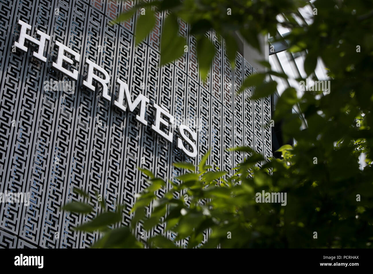 A logo sign outside of a Hermes retail store location in Denver ...
