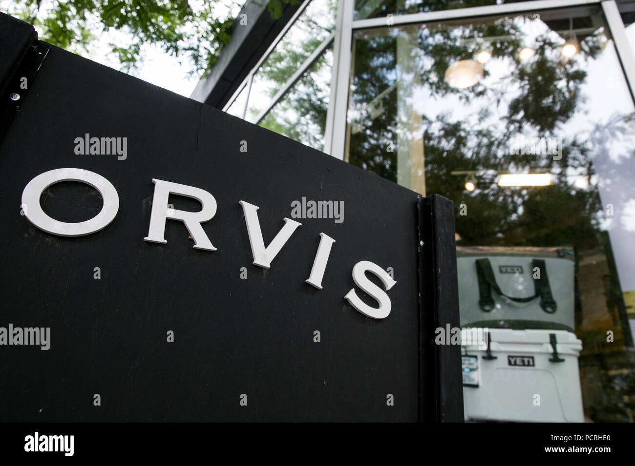 A logo sign outside of a Orvis retail store location in Denver ...