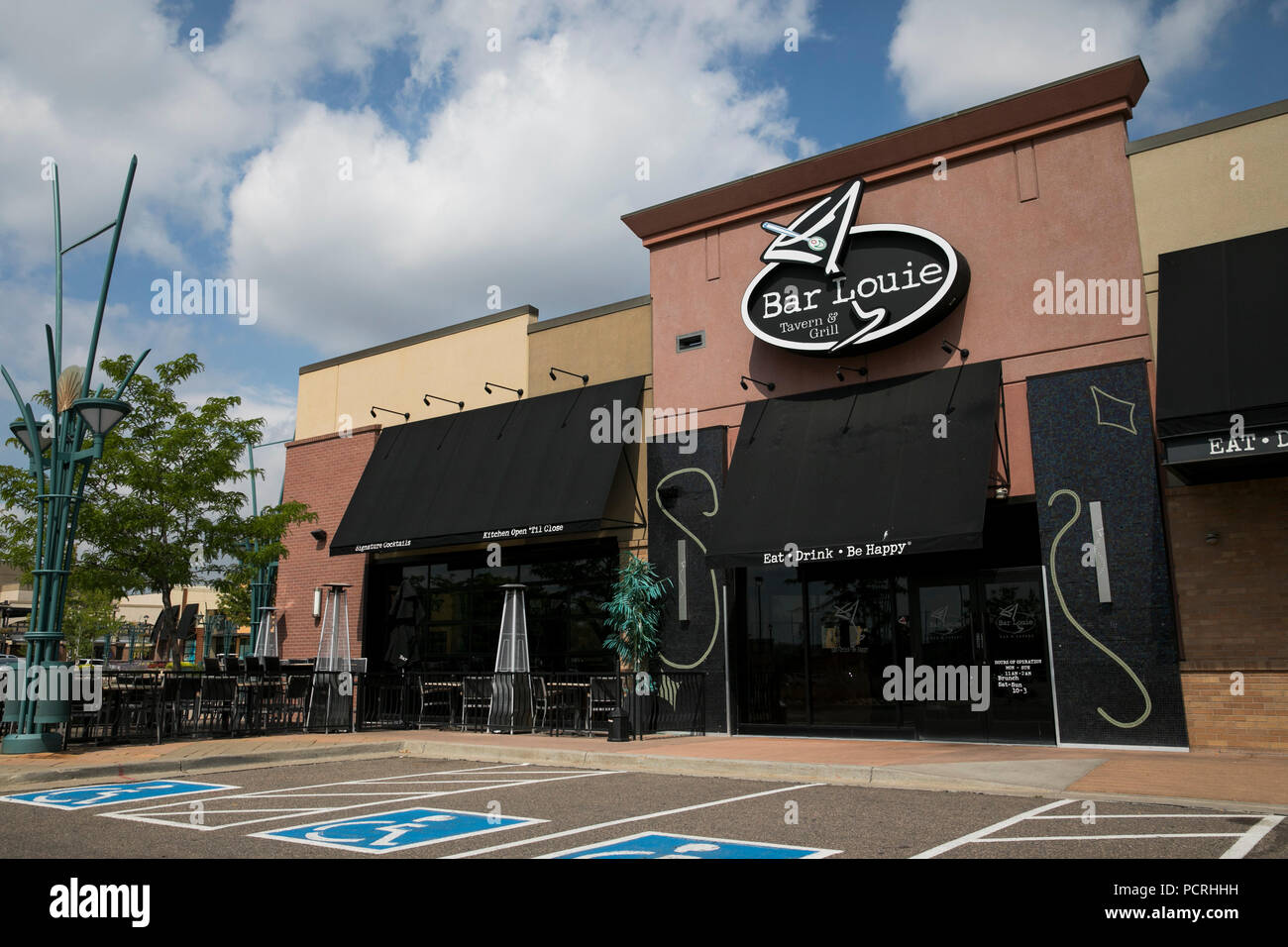 A logo sign outside of a Bar Louie restaurant location in Westminster ...