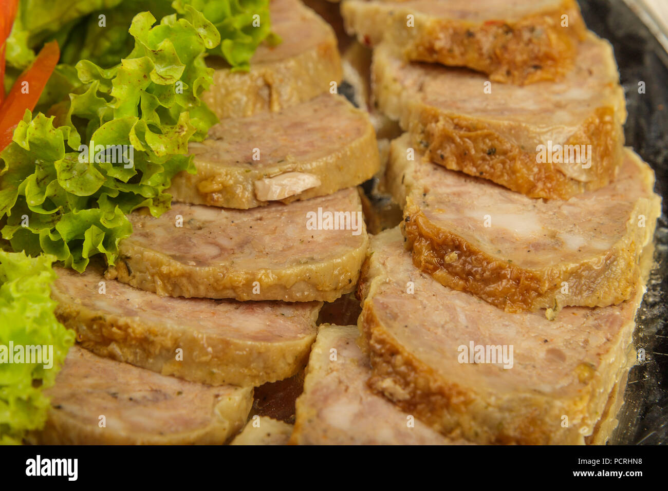 Meat sliced on a mirror dish decorated with verdure Stock Photo - Alamy