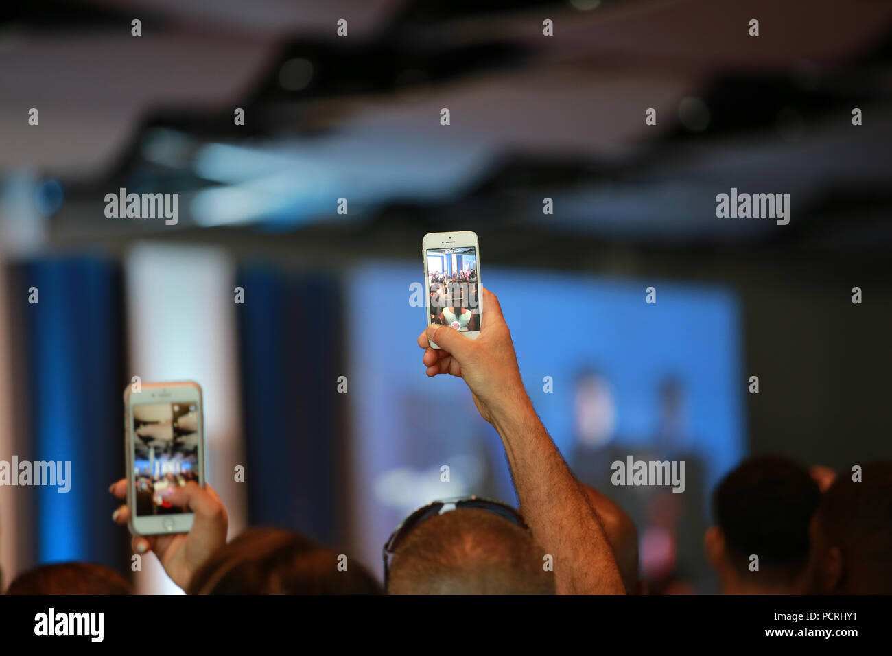people taking pictures at an event Stock Photo - Alamy