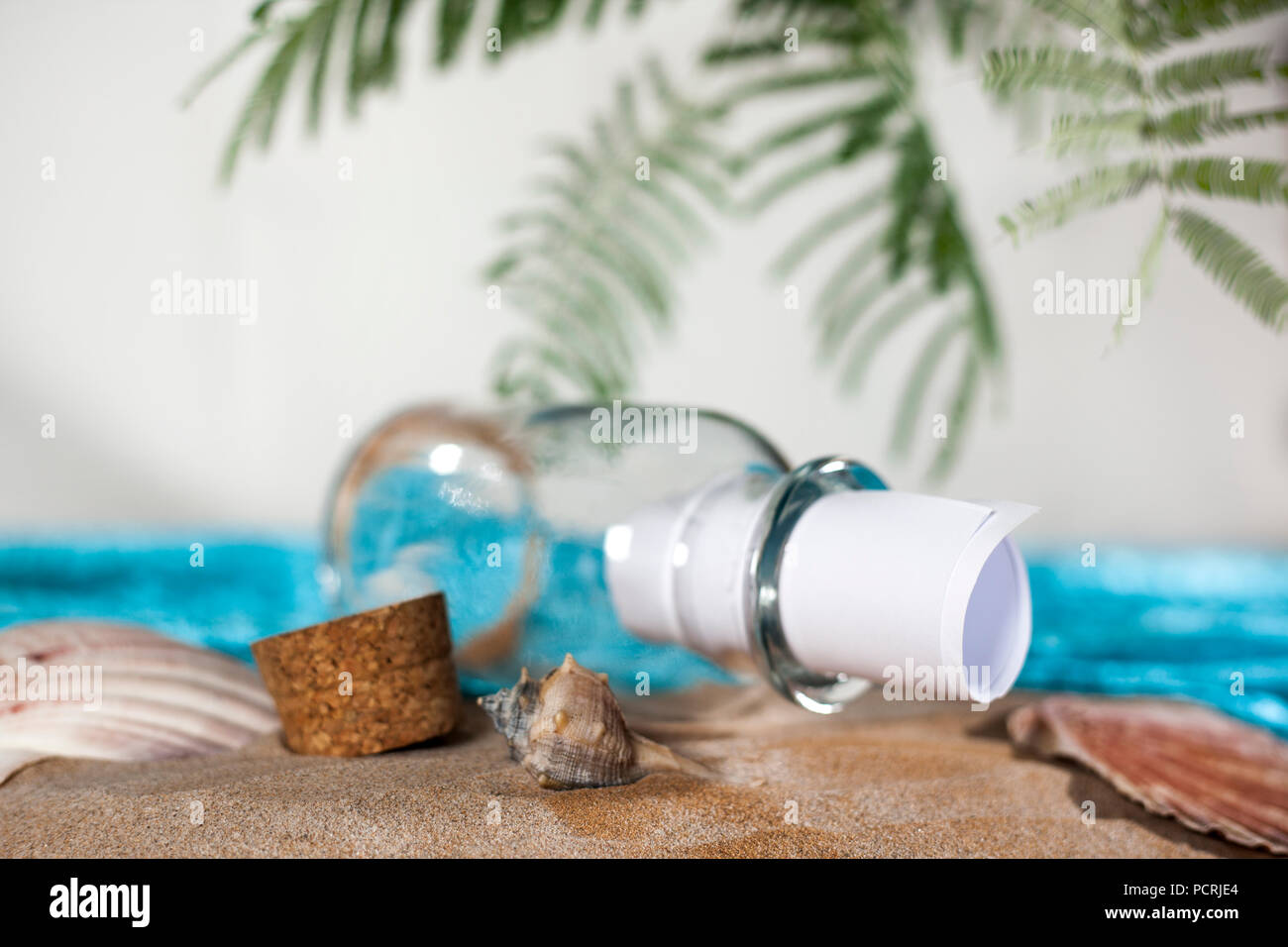 Stranded bottle message note paper with cork on a beautiful holiday ...