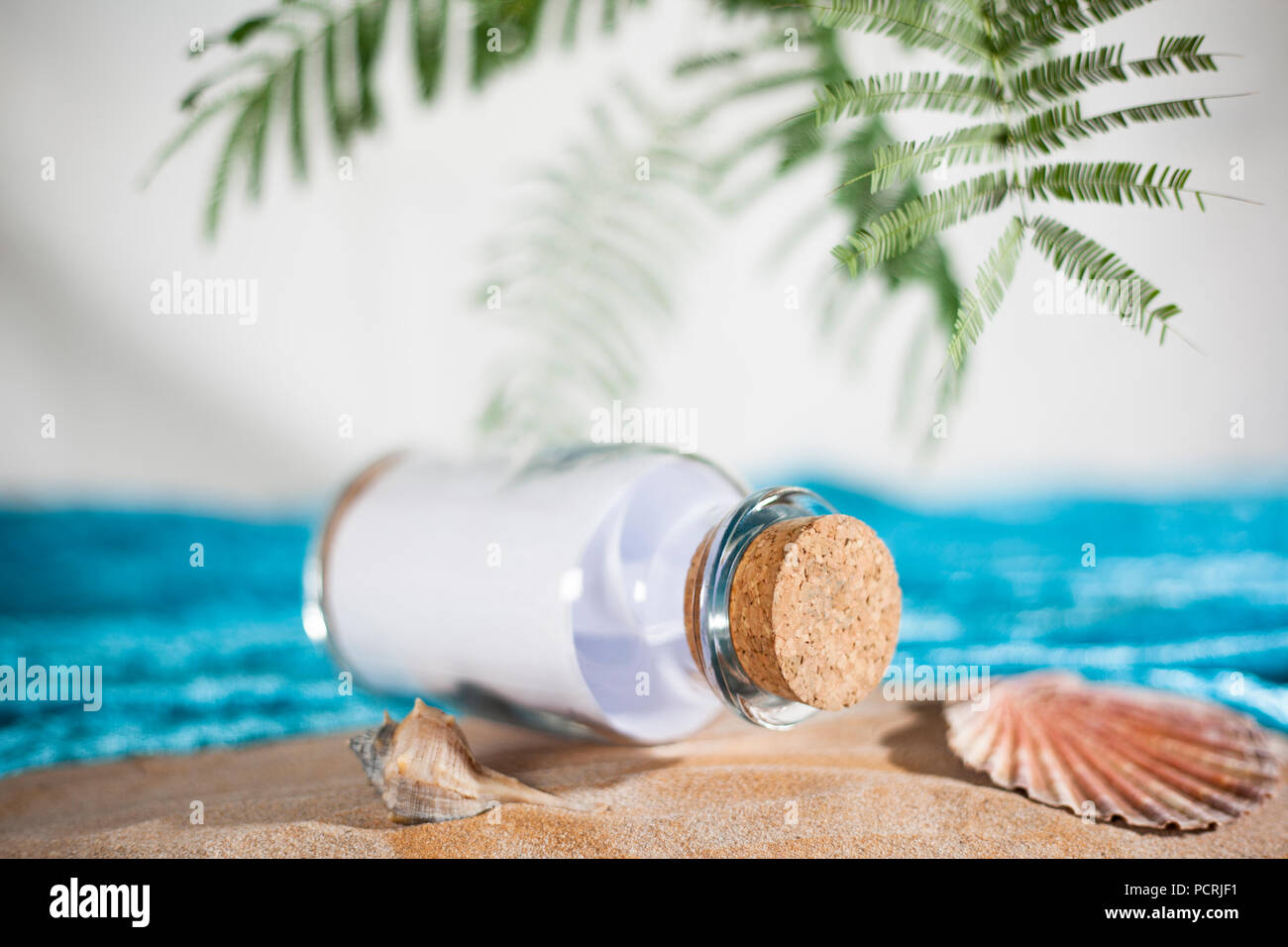 Stranded bottle message note with cork on a beautiful holiday beach ...