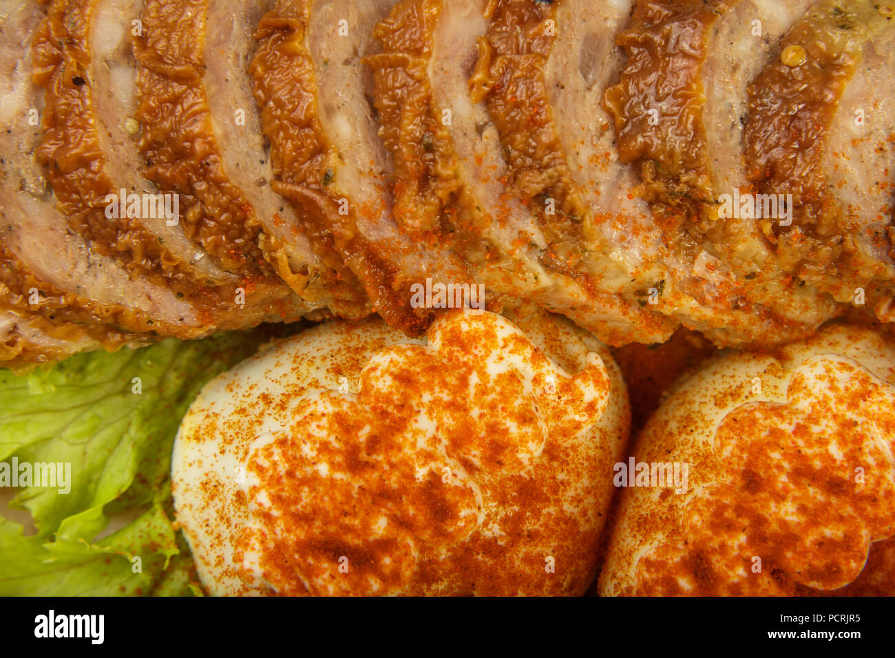 Meat sliced on a mirror dish decorated with verdure Stock Photo - Alamy