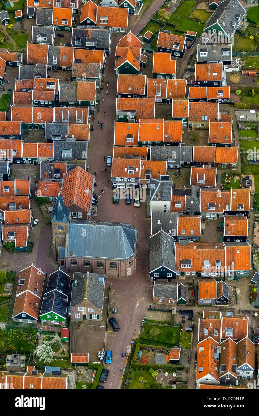 Marken island, with small fisherman's houses and the town church, red ...