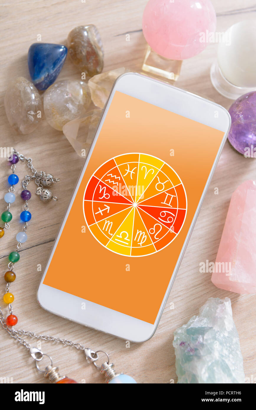 Zodiac signs and smart phone with crystals. Concept of modern astrology ...