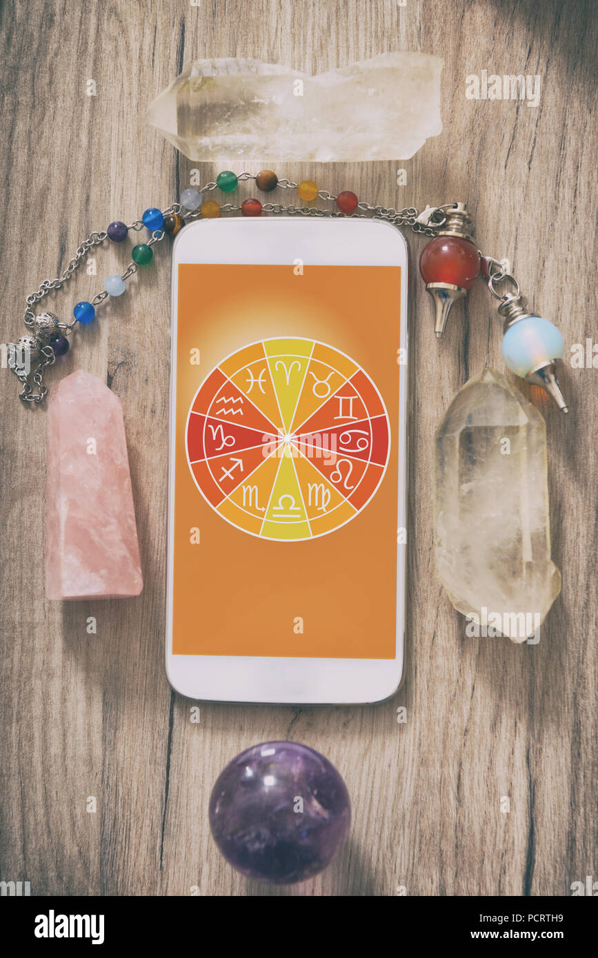 Zodiac signs and smart phone with crystal ball. Concept of modern ...
