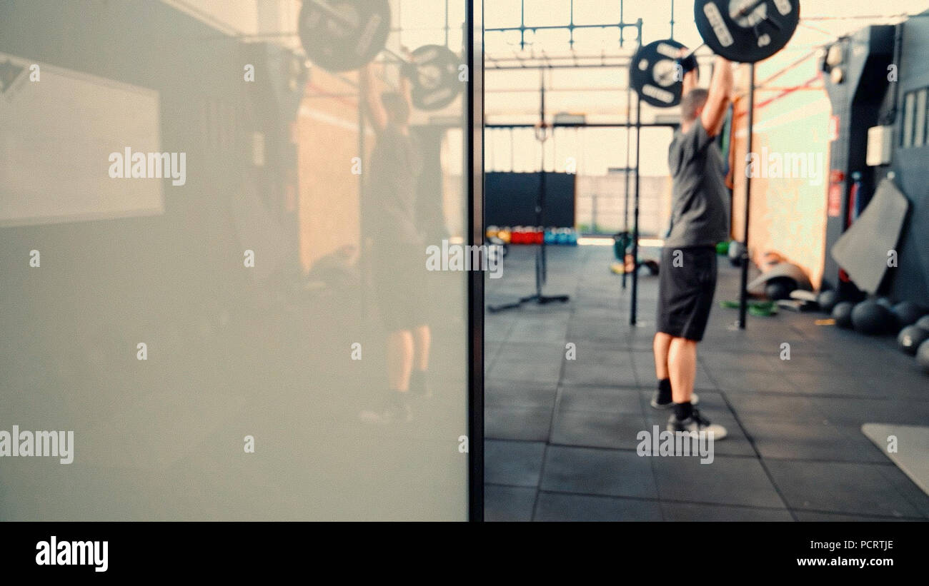 Man performing pull ups with heavy weights. Fitness exercise Stock ...