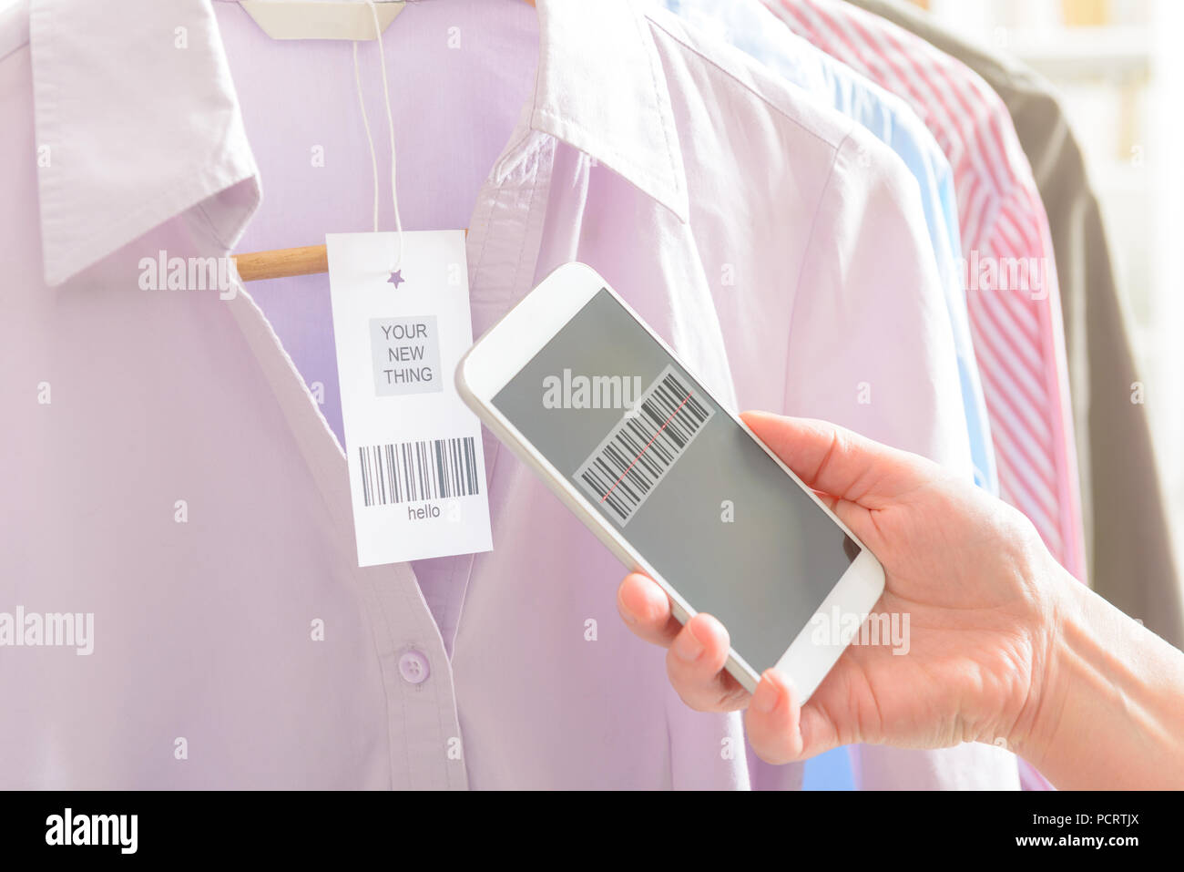 Woman scanning barcode from a label in a shop with mobile phone Stock ...