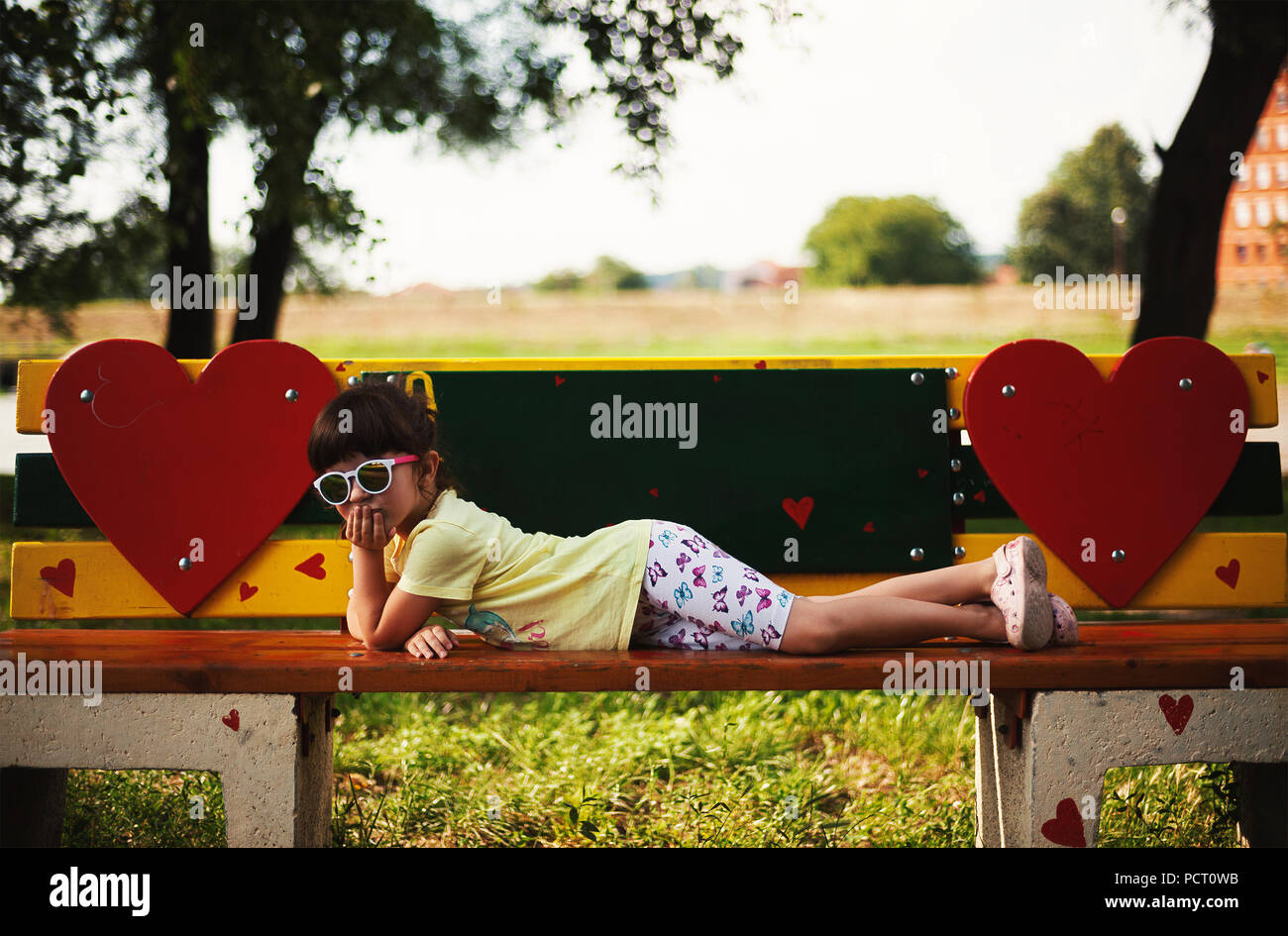 Girl posing on bench hi-res stock photography and images - Alamy