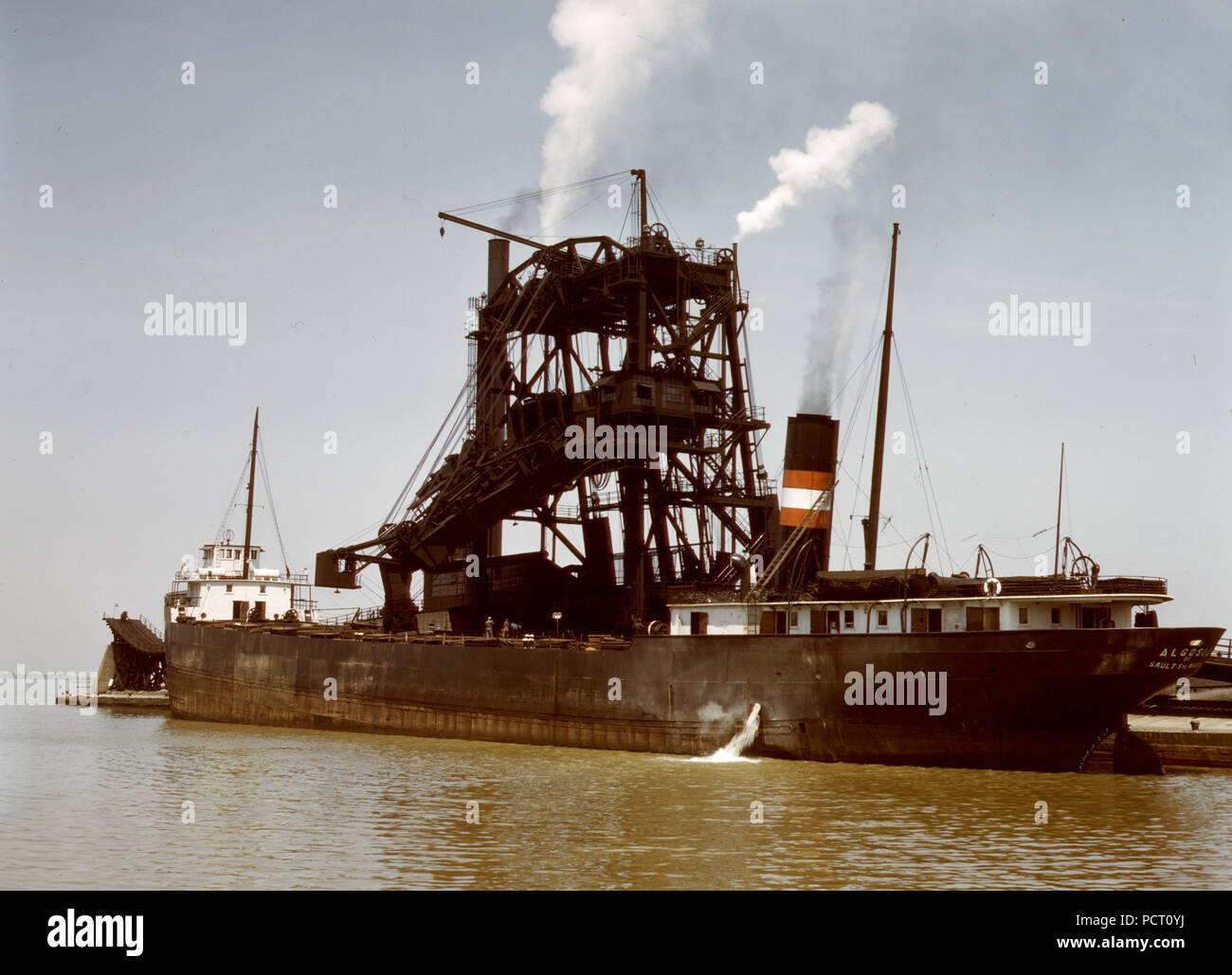 Loading coal into a freighter at one of the Pennsylvania Railroad docks ...