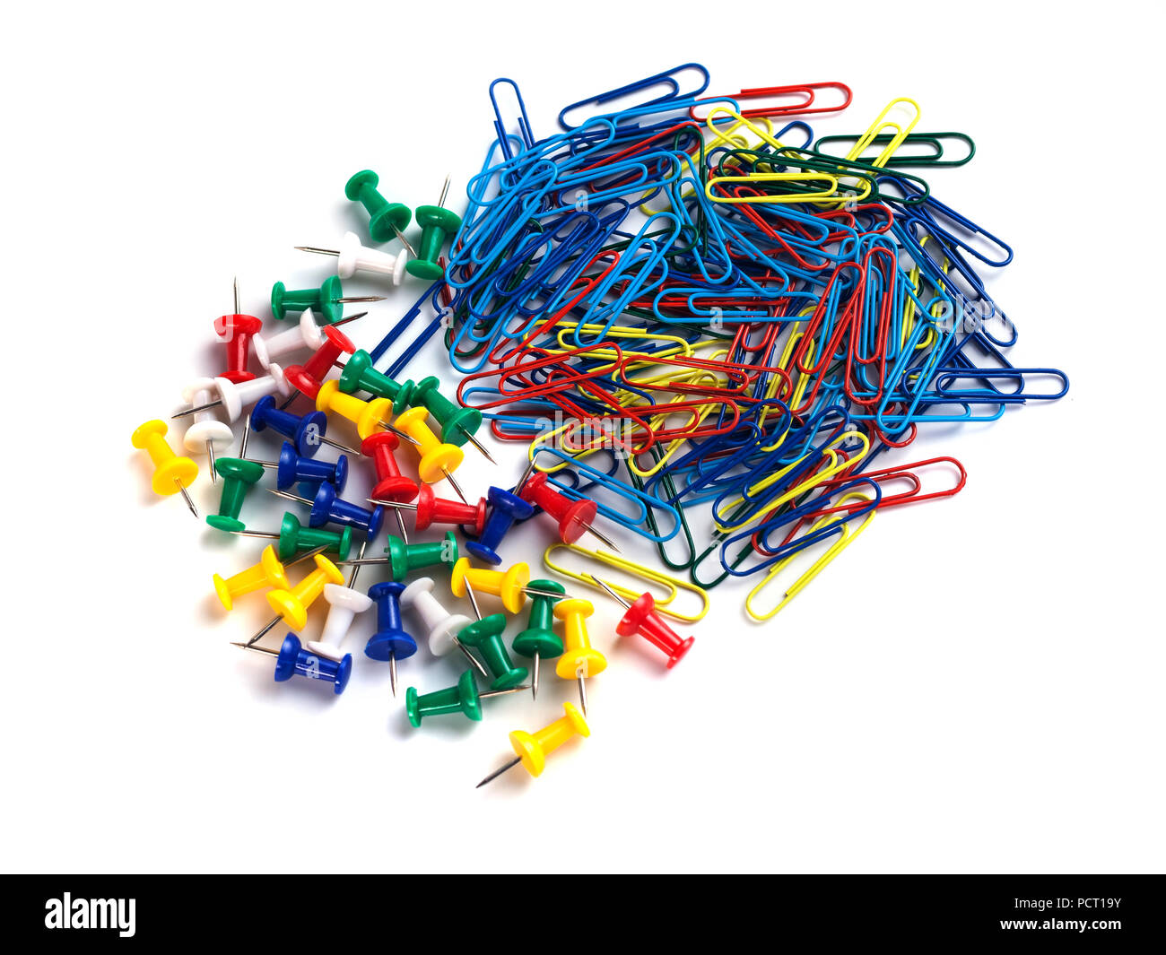 Bunch of colorful paper clips and tacks isolated on white background ...