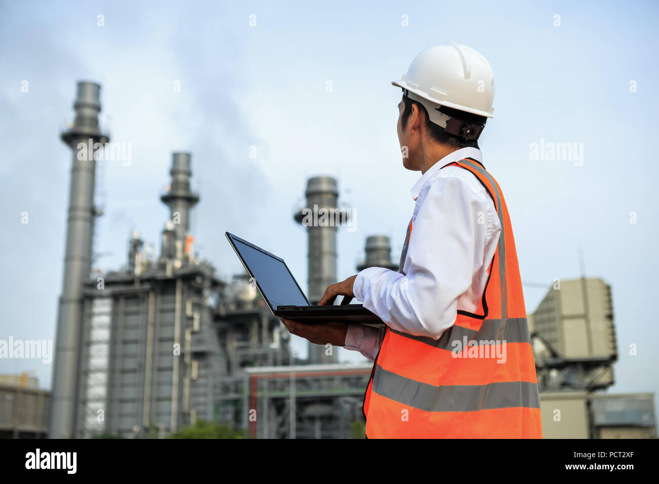 engineer check power plant with laptop Stock Photo - Alamy