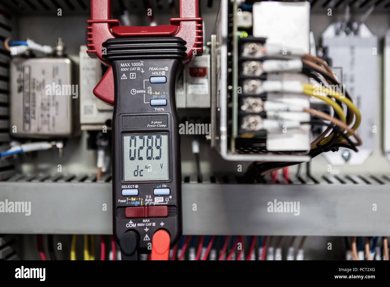 Electrical Engineer is check electrical equipment with a multi-meter ...