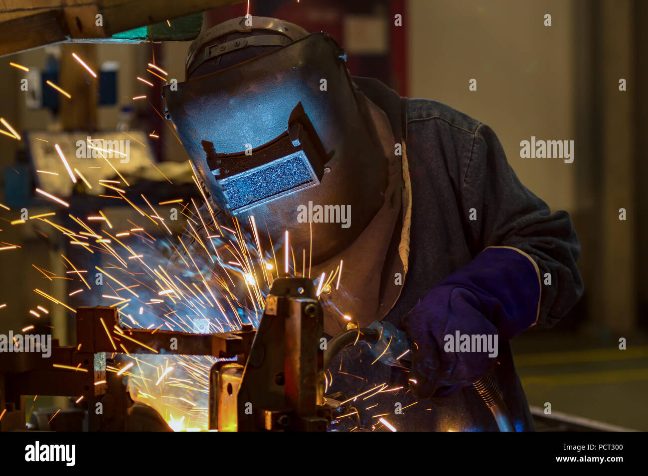 Welder is welding in factory Stock Photo - Alamy