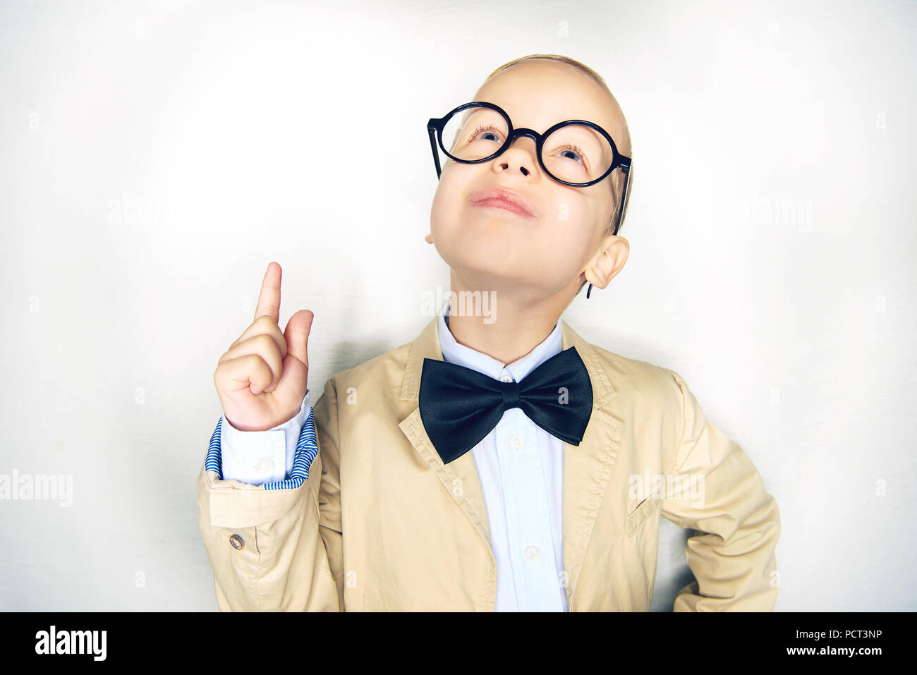 Smiling little blonde boy dressed like a professor wearing a suit ...