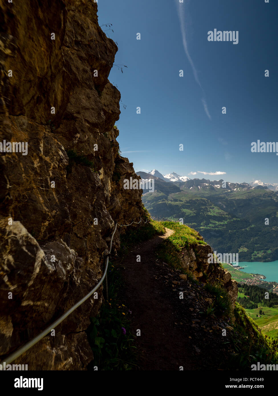 mountain hiking path alongside steep mountain ridge with scenic view ...