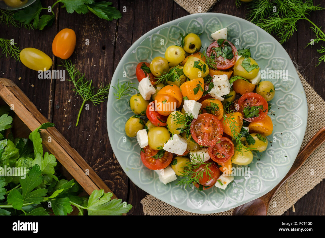 Fresh tomato olives salad, herbs and feta cheese inside Stock Photo - Alamy